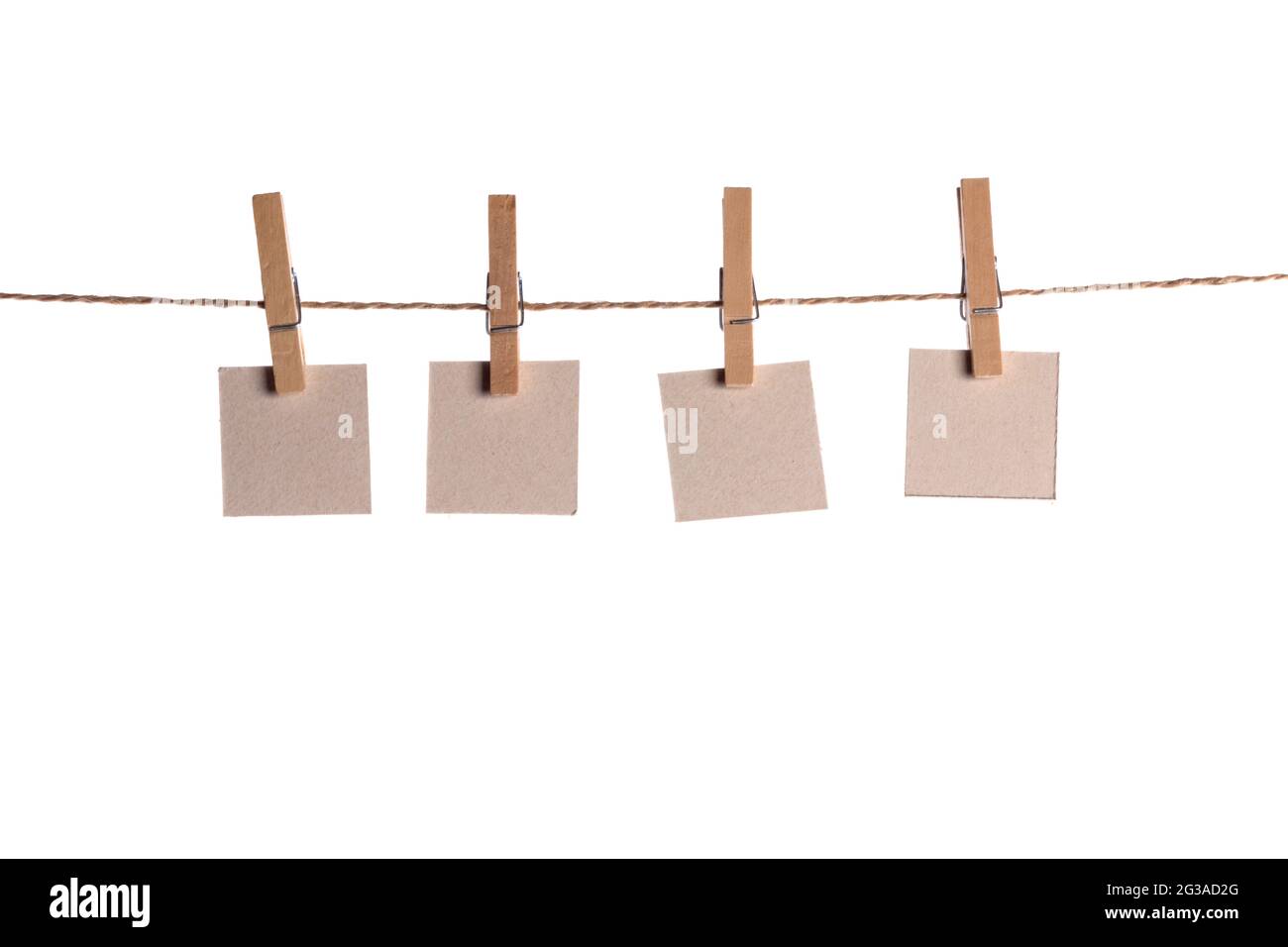 Four paper blank notes hanging on the rope isolated on white background ...