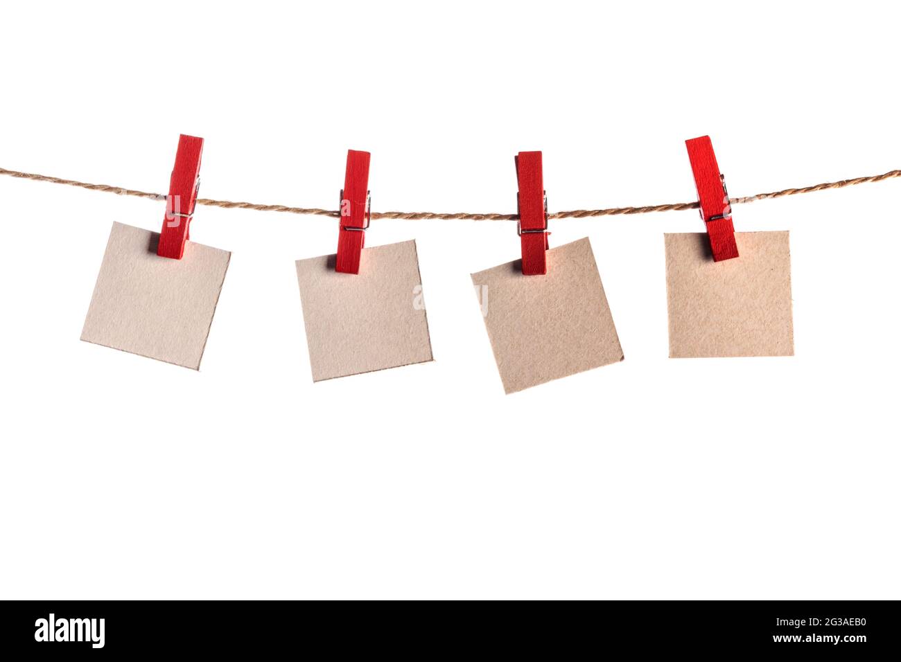 Four paper blank notes hanging on the rope isolated on white background ...