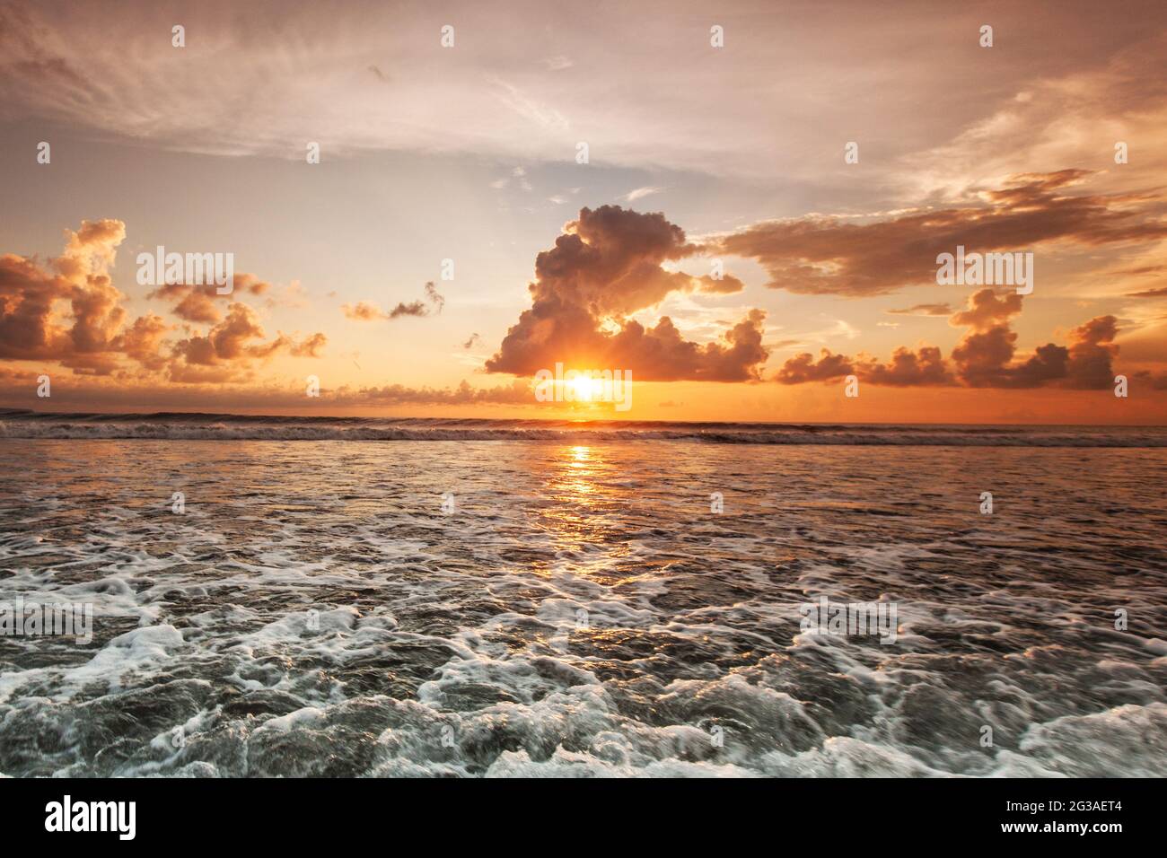 Colorful ocean beach sunset, cloudy sky and sea surf Stock Photo - Alamy