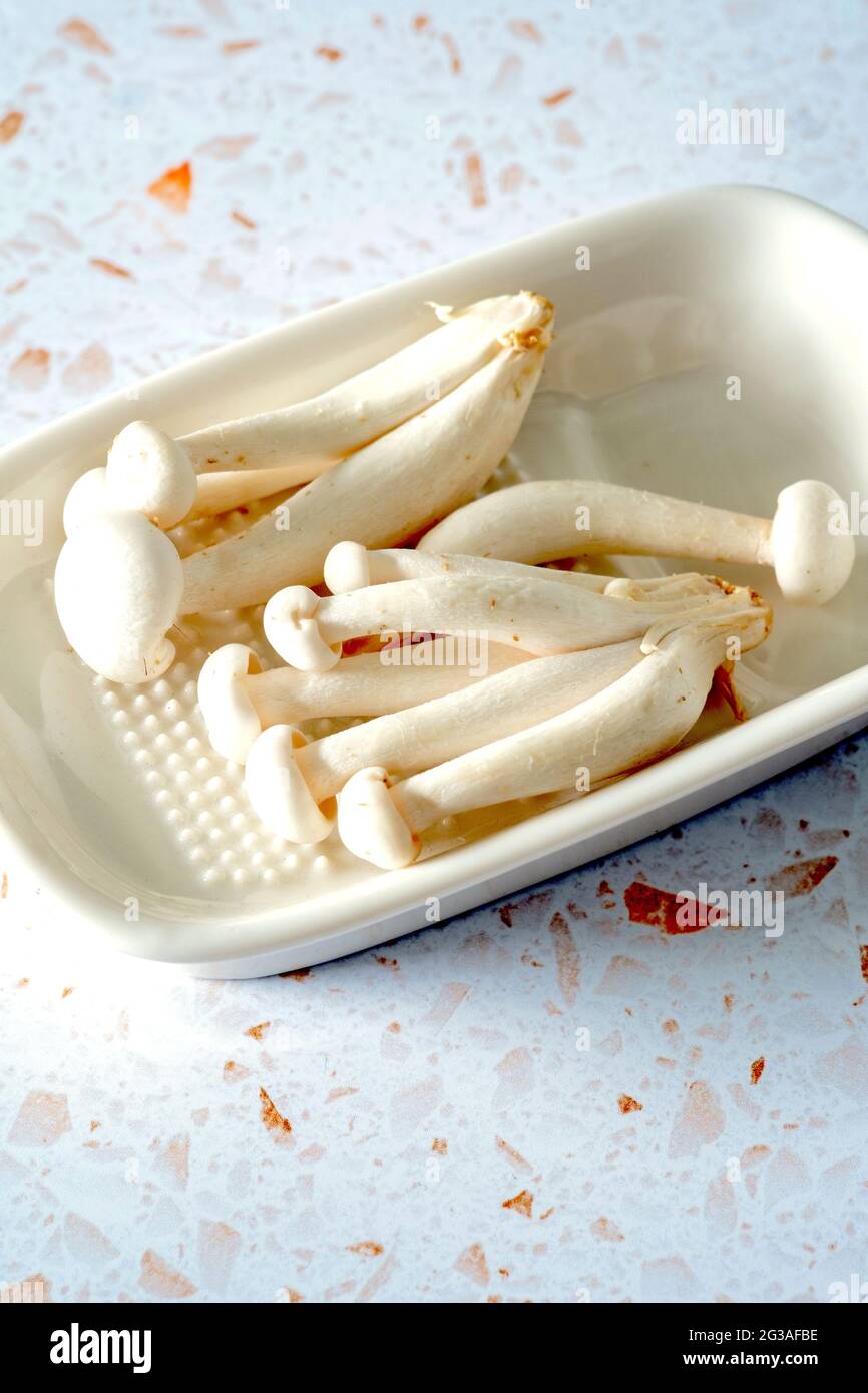 White Asian Enoki mushroom, raw vegan food, fungus, close-up Stock ...