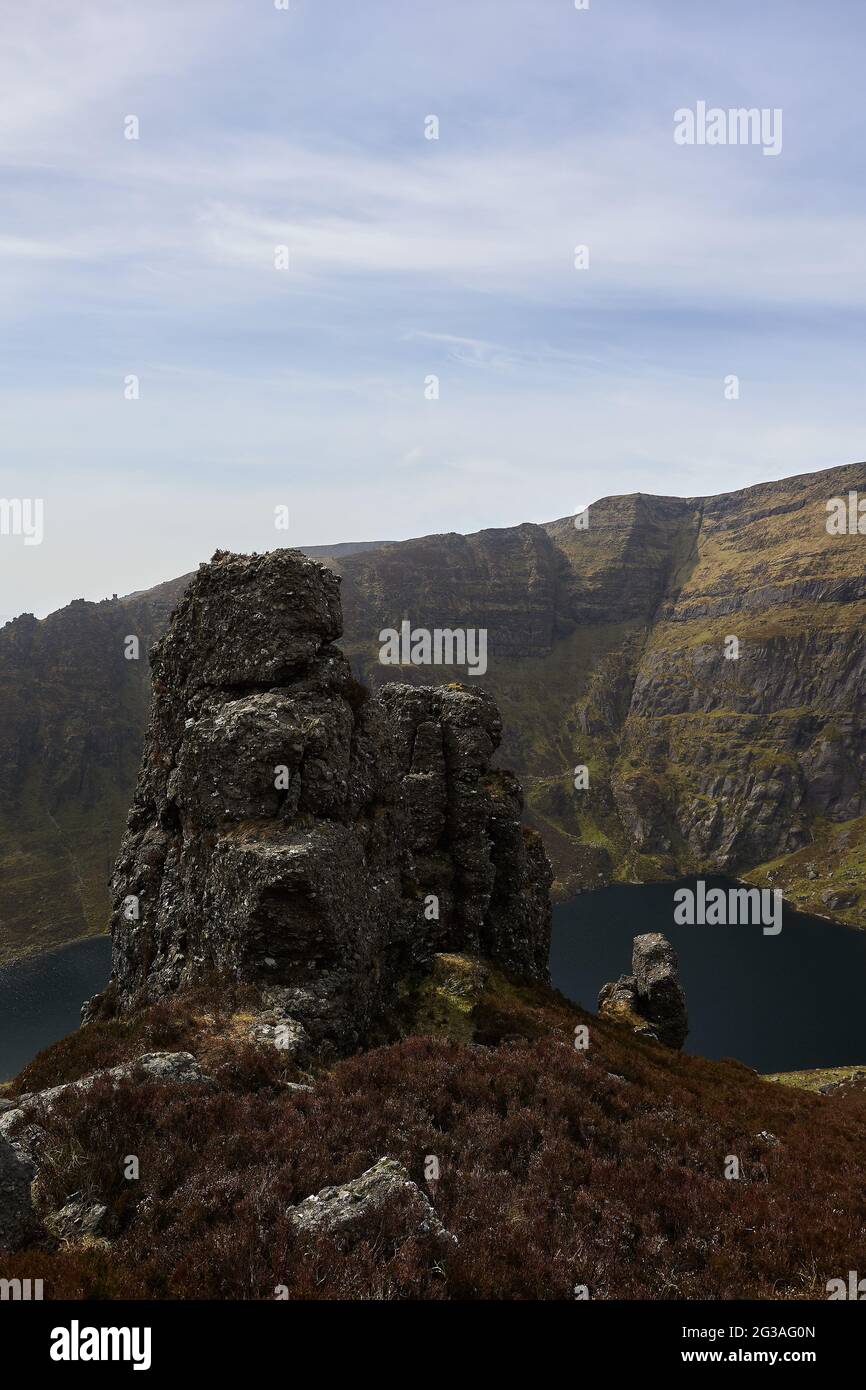 huge rock on a mountain with a bottom lake in a valley. Comeragh ...
