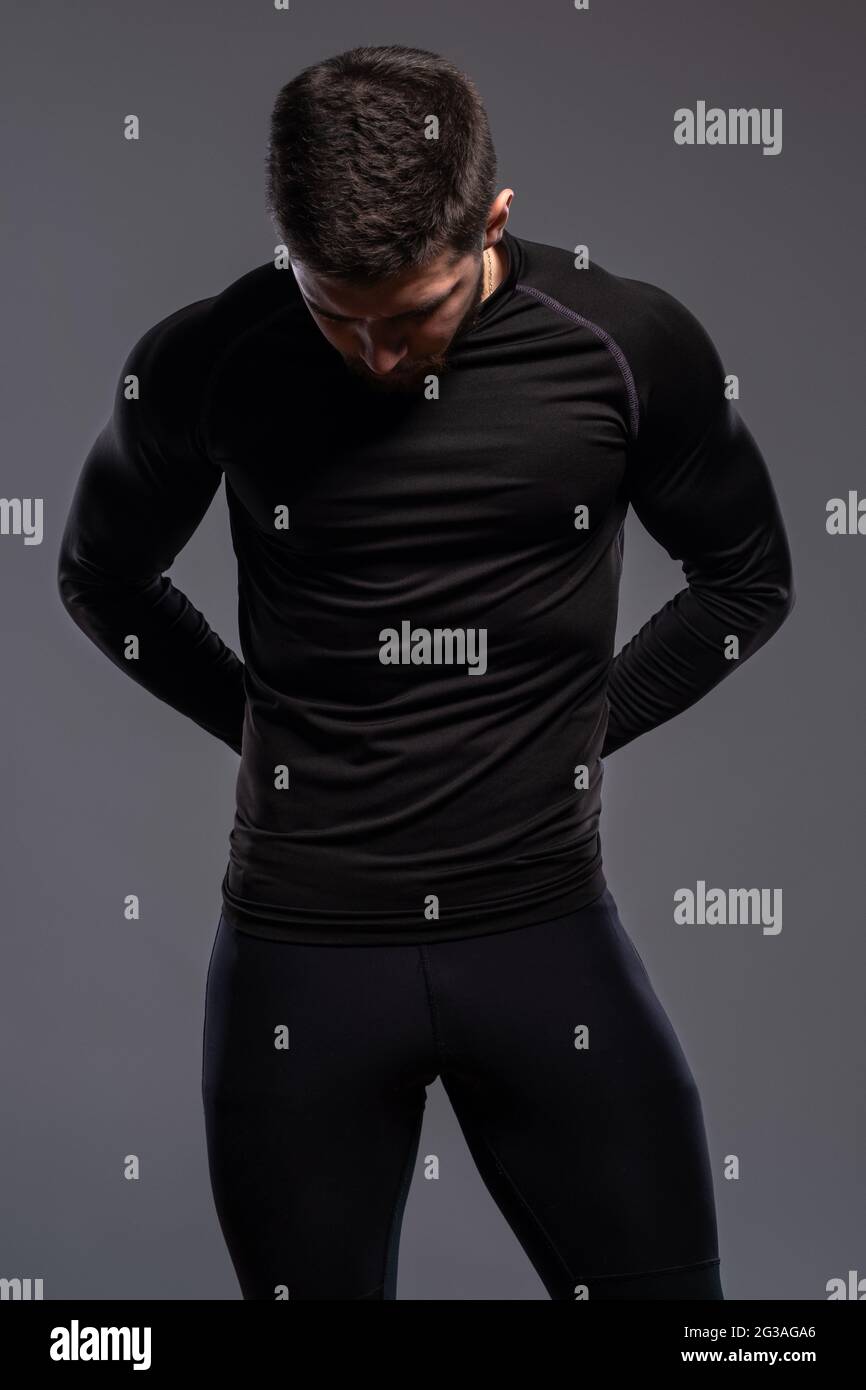 Athlete standing with head down and arms behind back Stock Photo - Alamy
