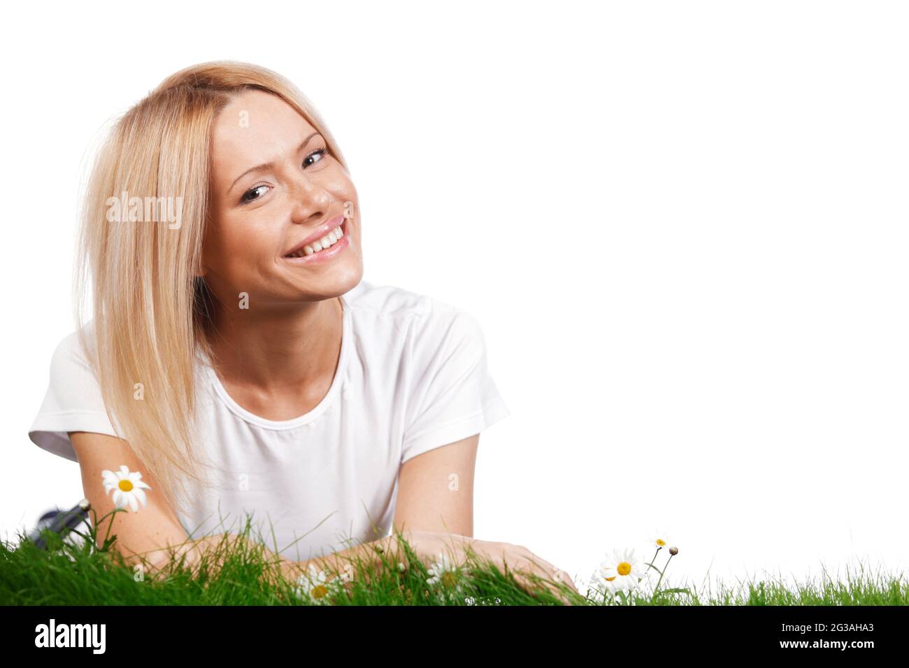 Beautiful Young Blonde Woman Lying On Grass With Chamomile Flowers