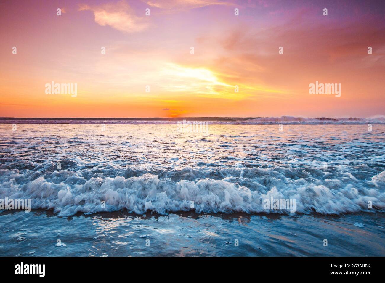 Radiant sunset from Bali Double Six beach surf waves and colorful ...