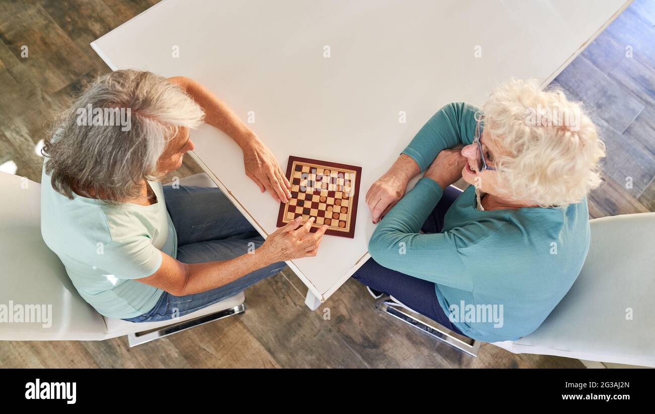 Senior women friends playing game hi-res stock photography and images ...