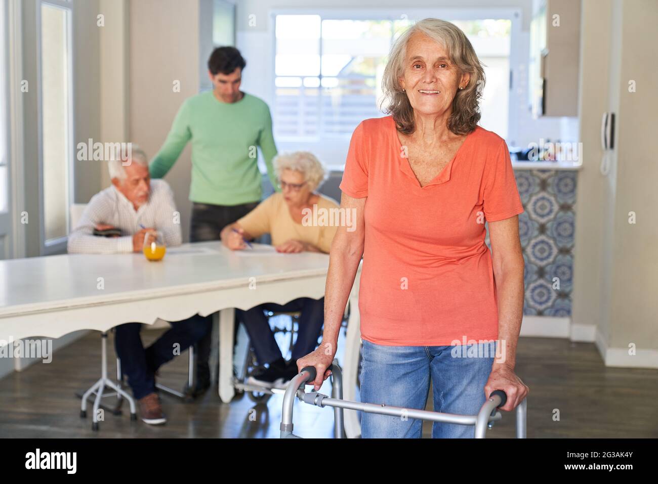 Senior woman with walking aid after a stroke in a nursing home or in ...