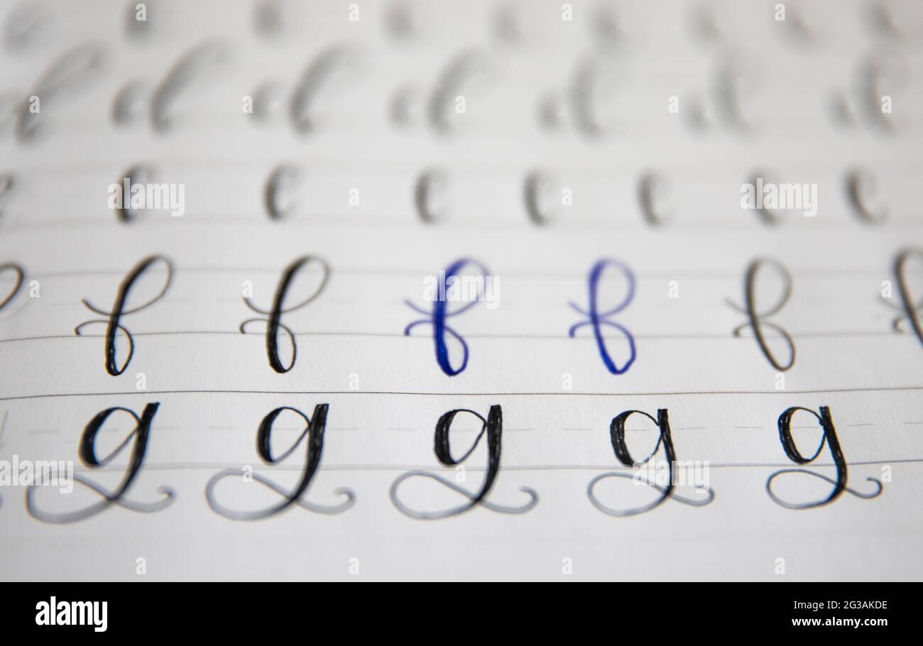 modern calligraphy letters in a practice book Stock Photo - Alamy