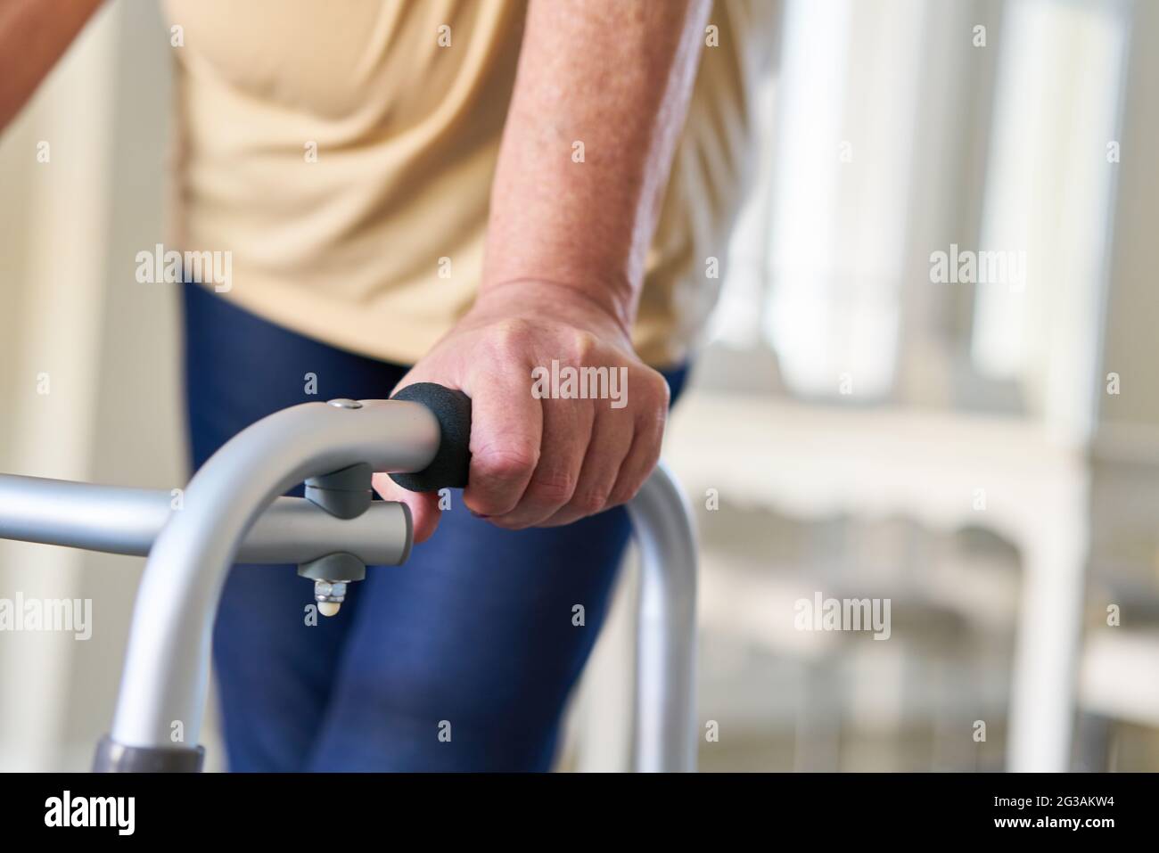 Senior disabled patient leans on a rollator in the rehabilitation ...
