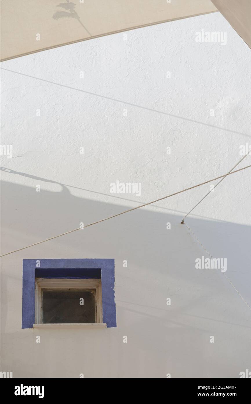 A white building with blue window frames in the Greek style. Travel and ...