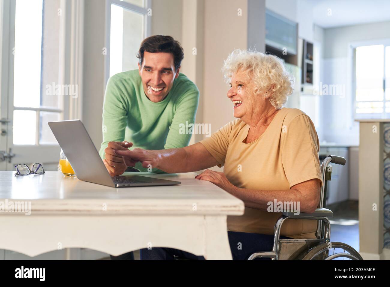 Man helping senior woman on laptop computer with video call or social ...