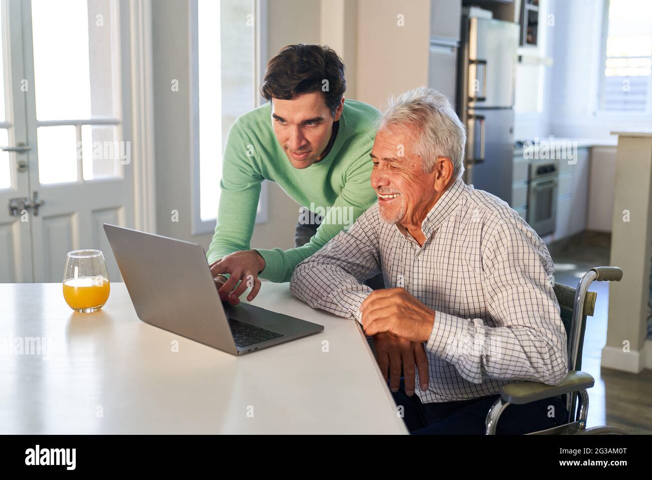 Young man in wheelchair with laptop hi-res stock photography and images ...