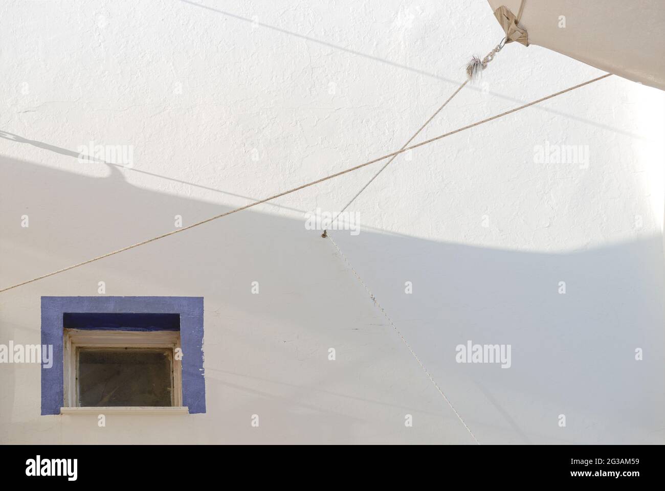 A white building with blue window frames in the Greek style. Travel and ...