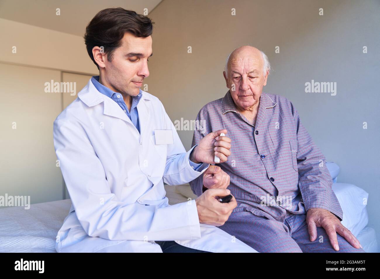 Nurse does blood glucose testing in senior with diabetes as a routine ...