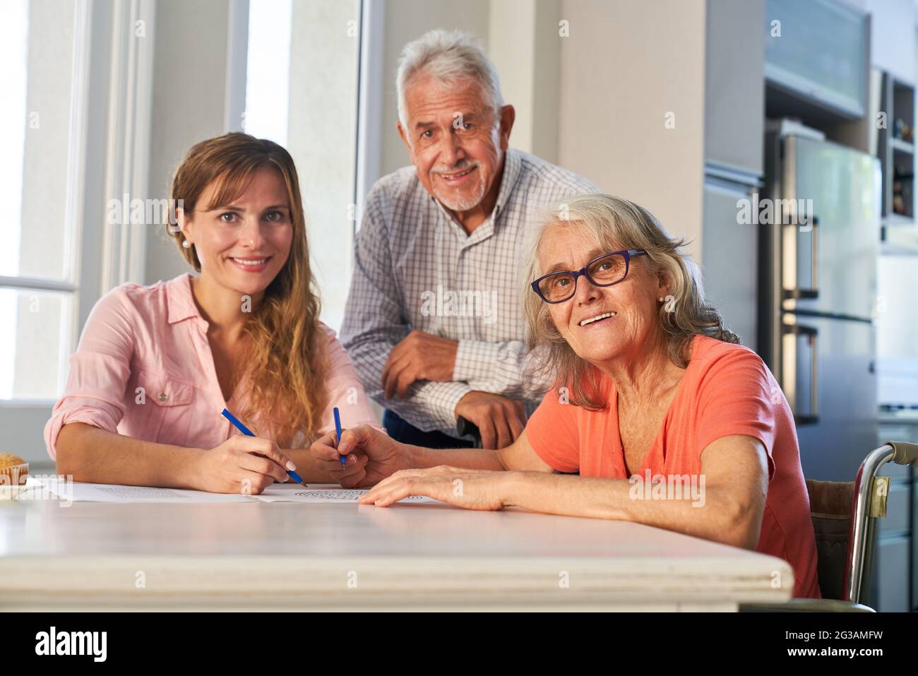 Young woman and senior parents during memory training against dementia ...