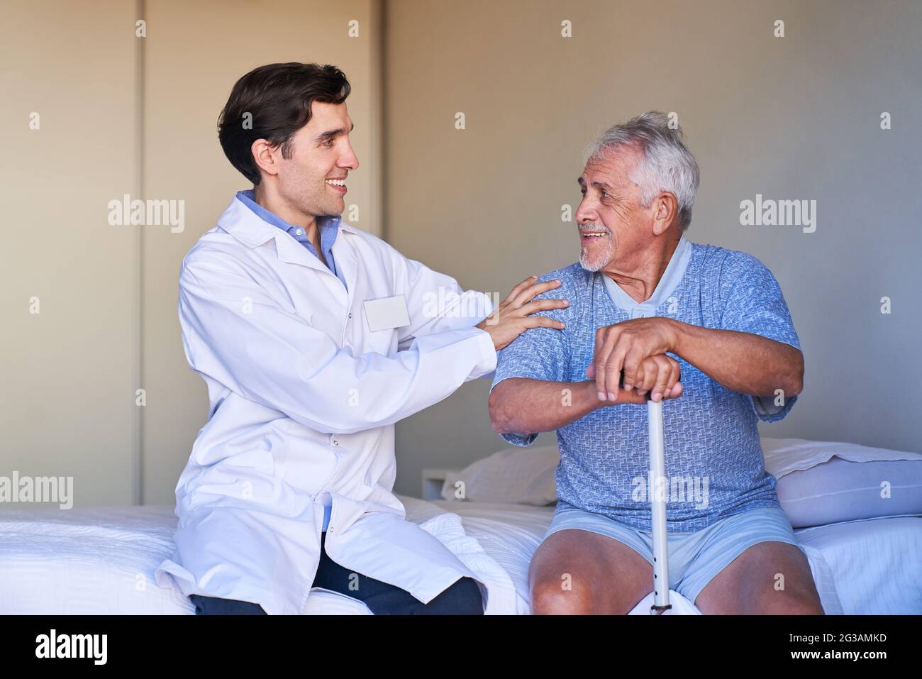 Young man as a geriatric nurse takes care of the elderly with an ...