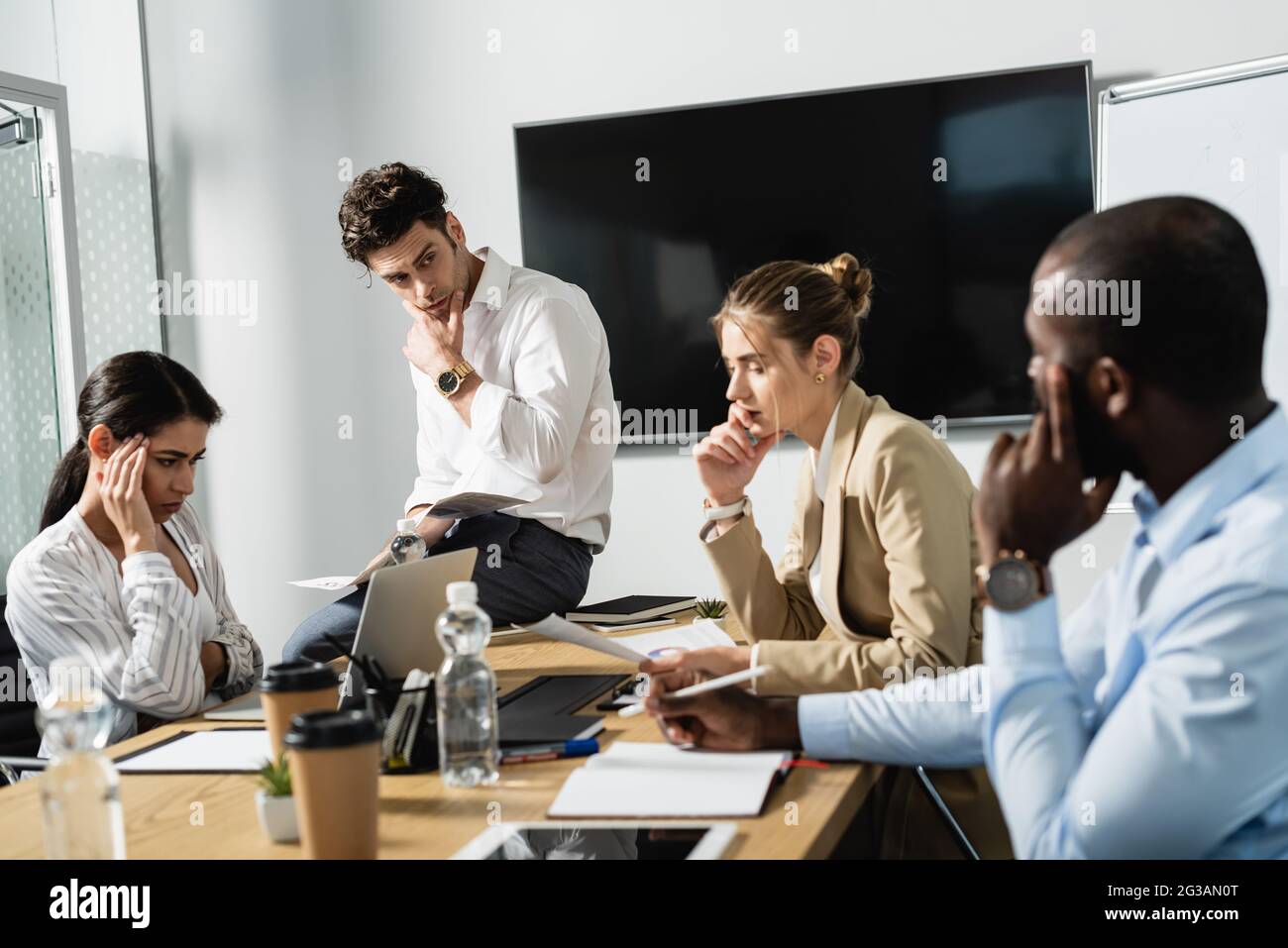 multiethnic business partners thinking during meeting in conference ...