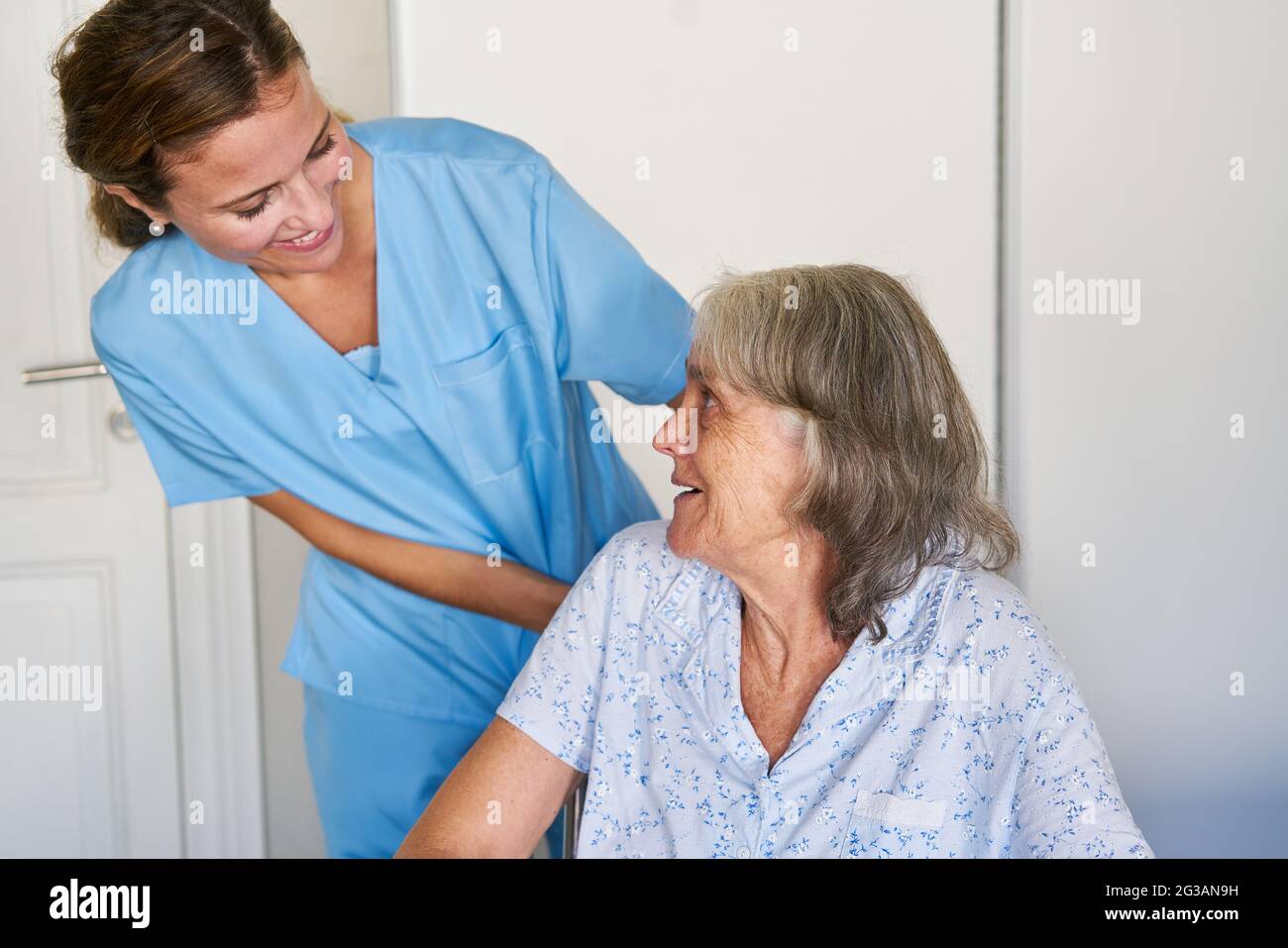 Young geriatric nurse takes care of the elderly in the nursing home or ...