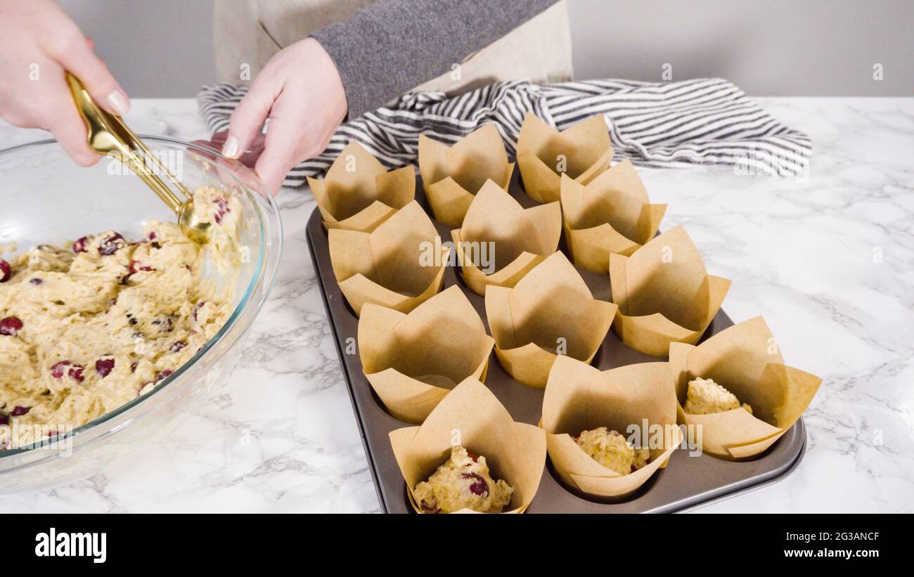 Step by step. Scooping dough into tulip muffin liners with mixture ...