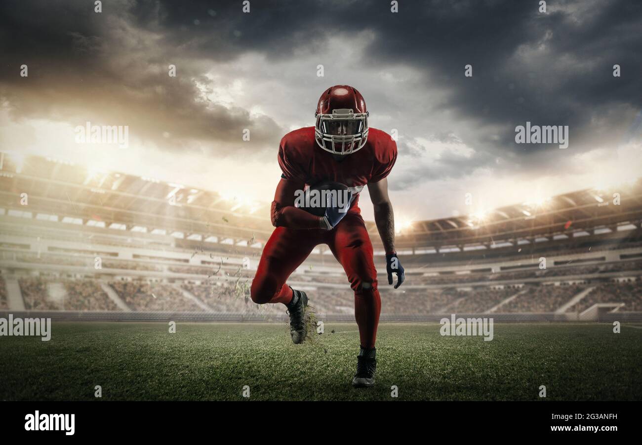 Young man american football player at stadium in motion. Action ...
