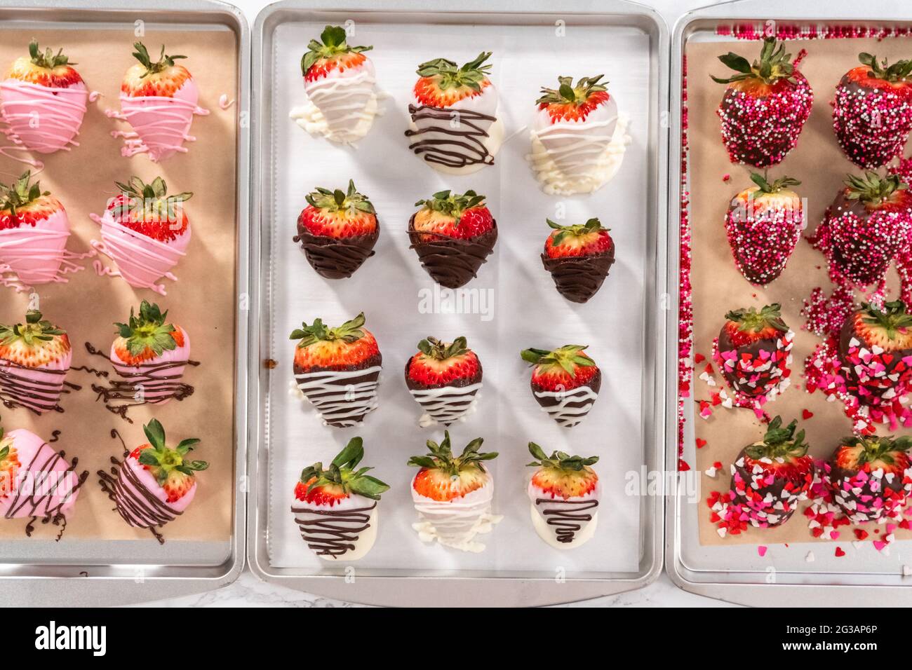 Flat lay. Variety of chocolate dipped strawberries on parchment paper ...