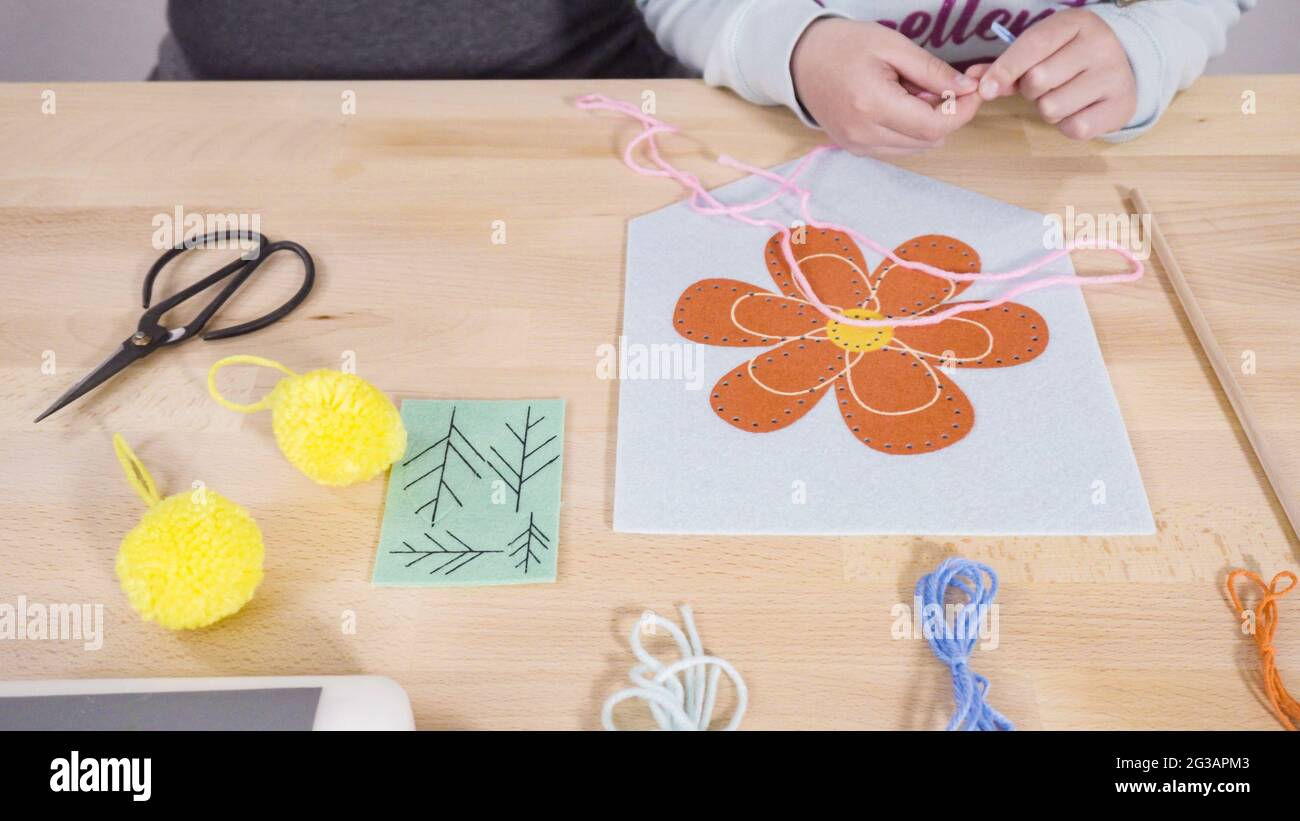 Little girl learning how to sew with sewing craft kit for kids Stock ...