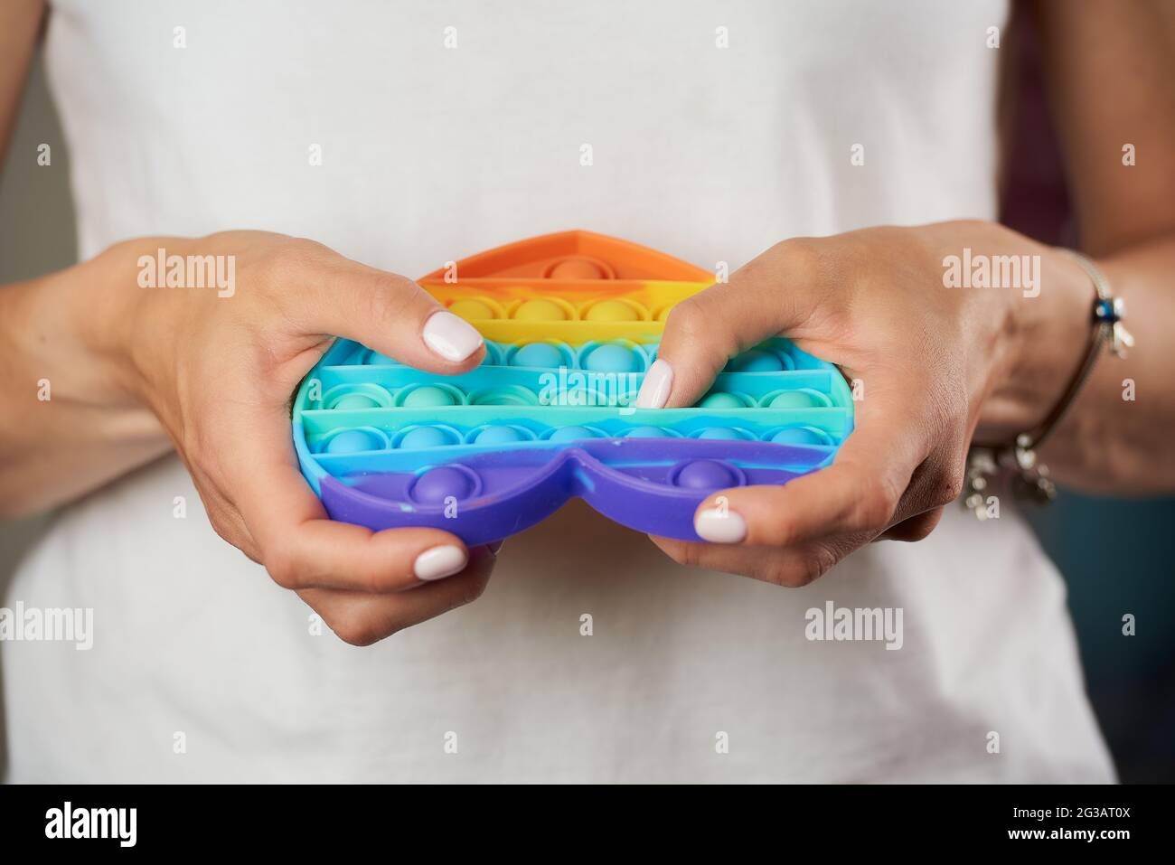 A close-up photo of a fidget toy "Pop it" in the shape of a heart in ...