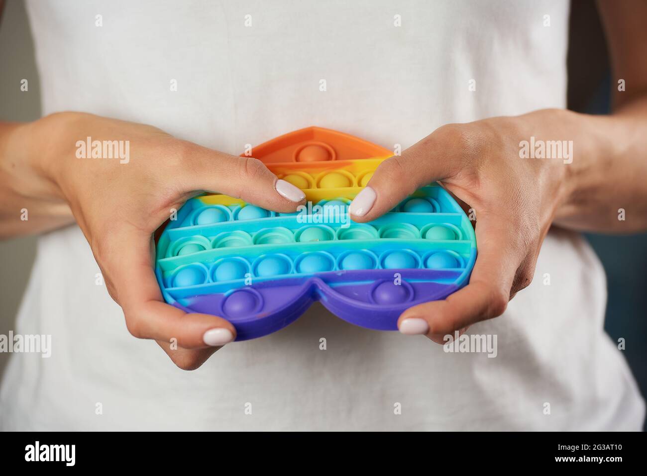 A close-up photo from above of a fidget toy "Pop it" in the shape of a ...