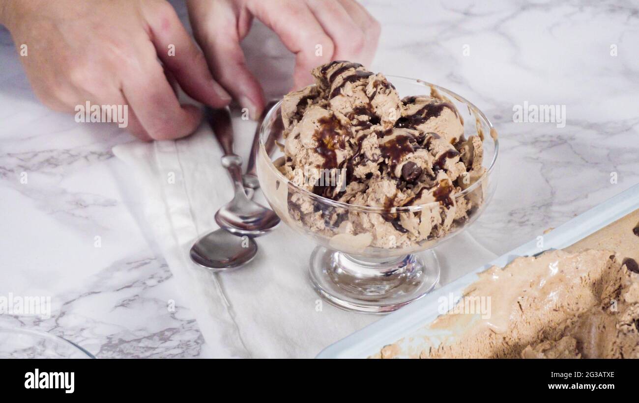 Homemade chocolate ice cream garnished with chocolate in a glass ice ...
