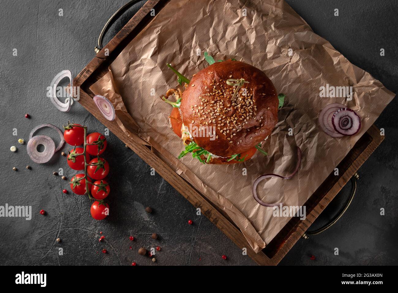 big american chicken curry burger on a black background. cutlet with ...