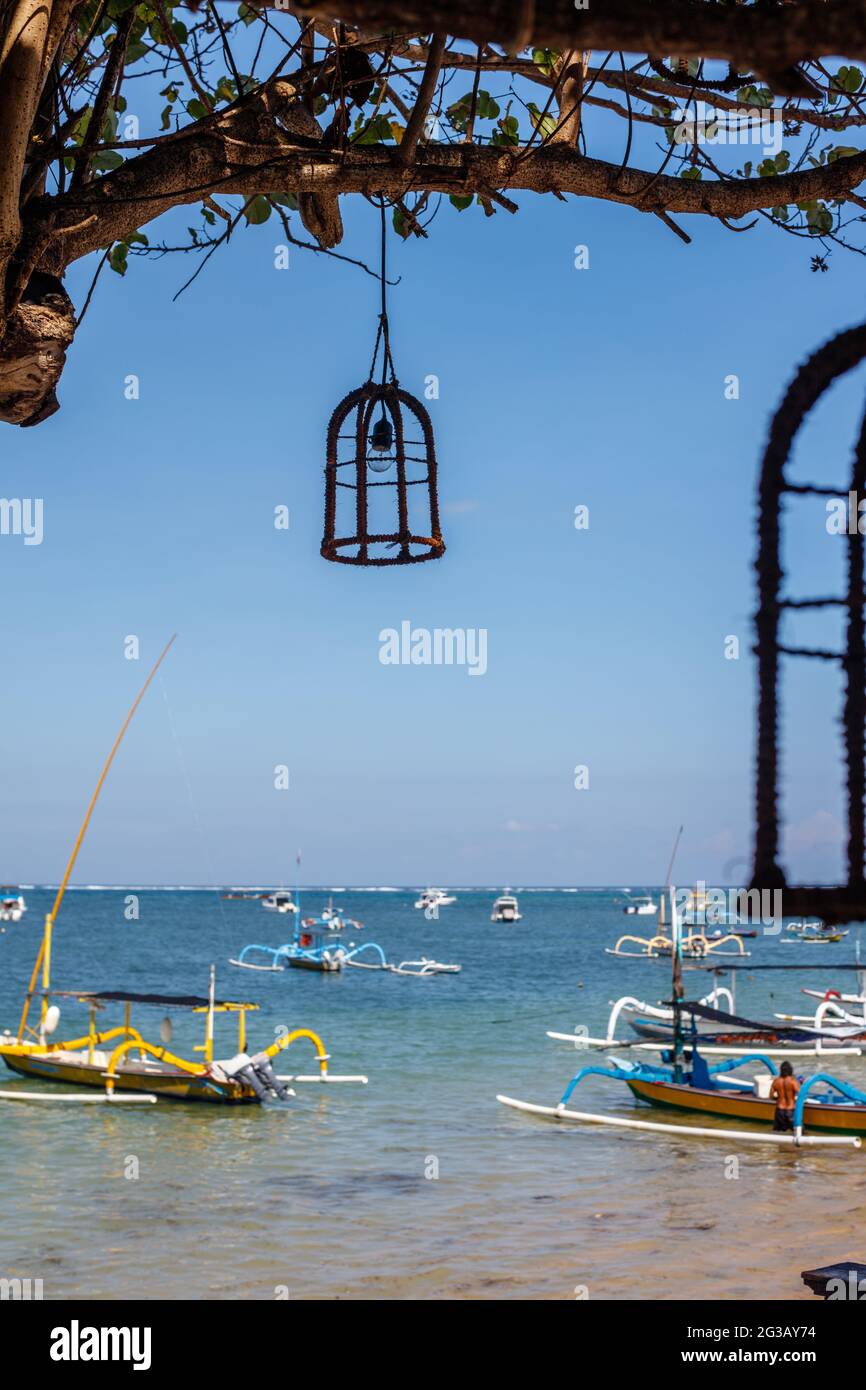Traditional Indonesian outrigger style wooden fishing boat (jukung ...