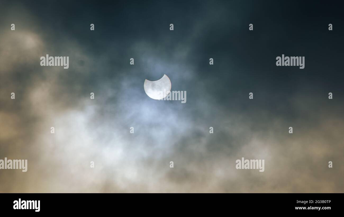 BRACKNELL, UNITED KINGDOM - Jun 10, 2021: Partial solar eclipse in a ...