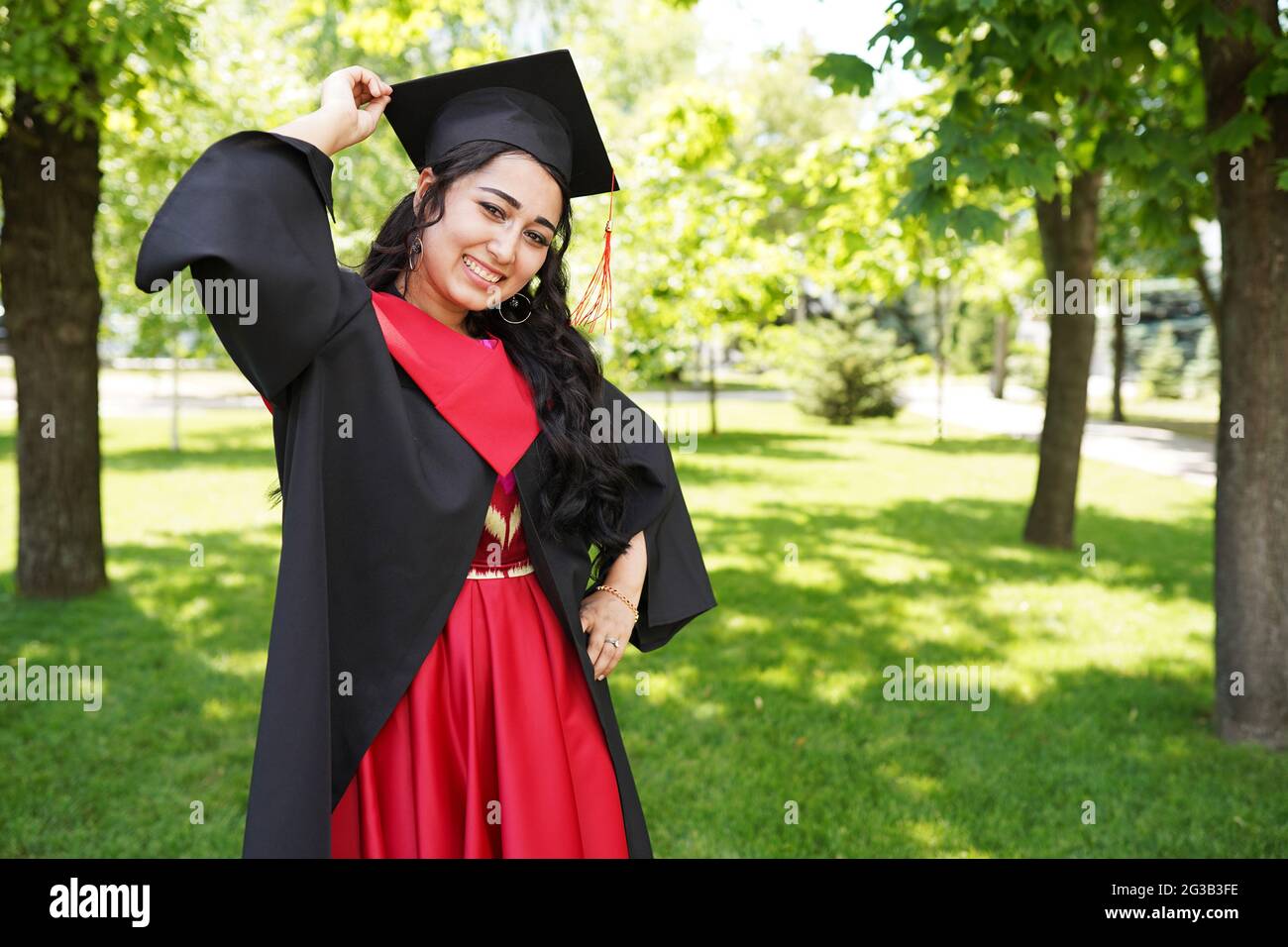 successful happy graduating student with nature green background near ...