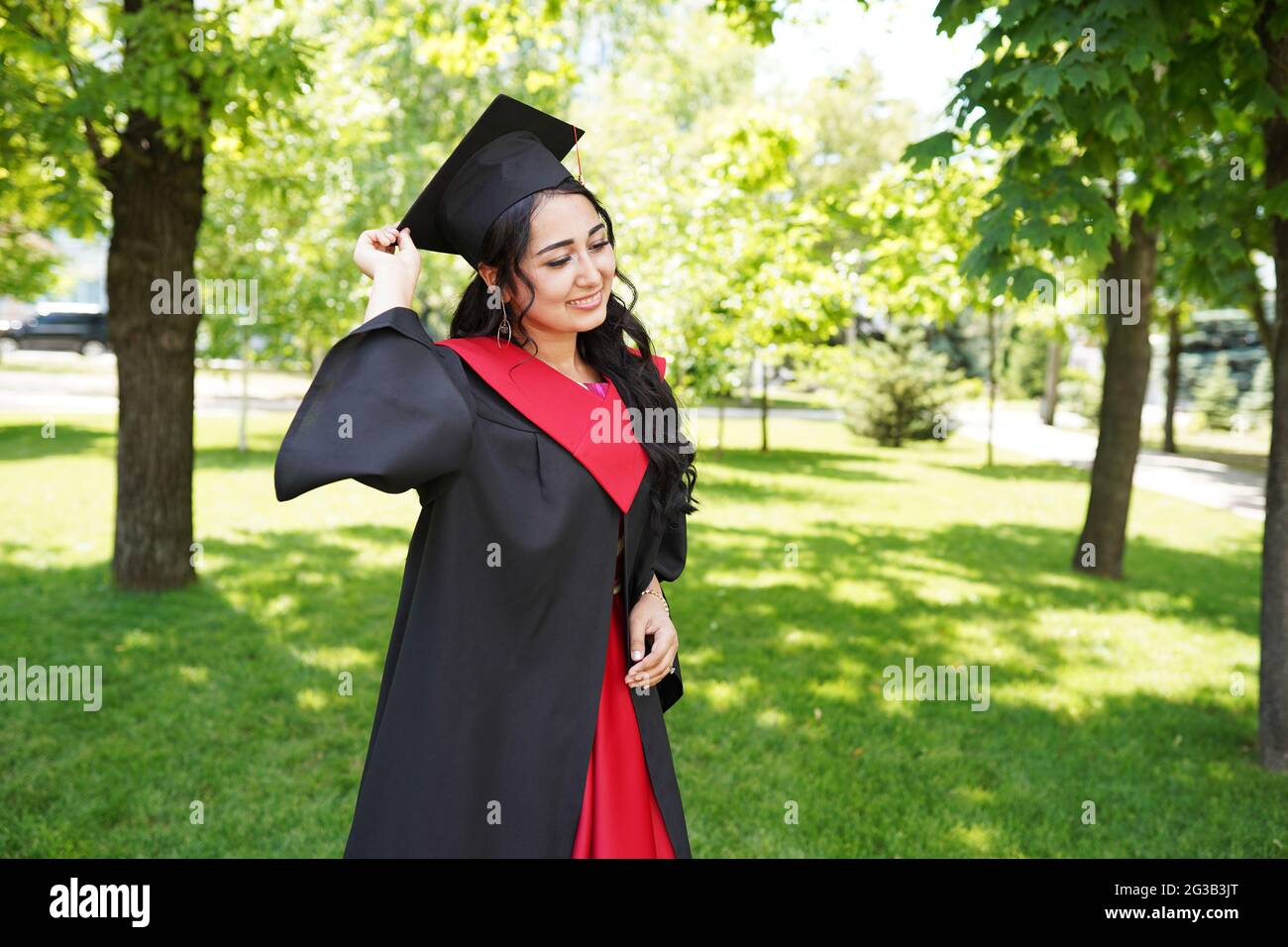 successful happy graduating student with nature green background near ...