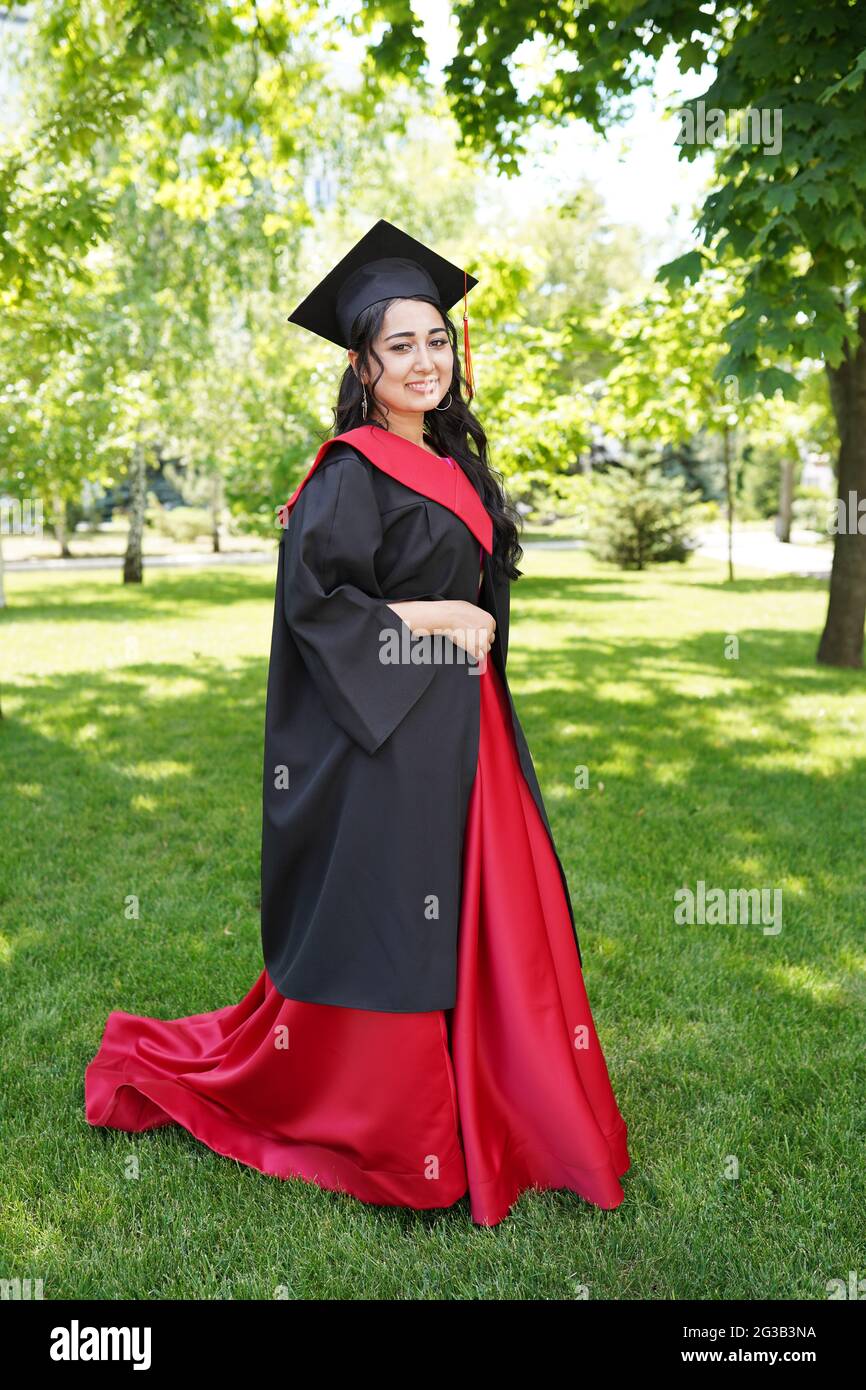 successful happy graduating student with nature green background near ...