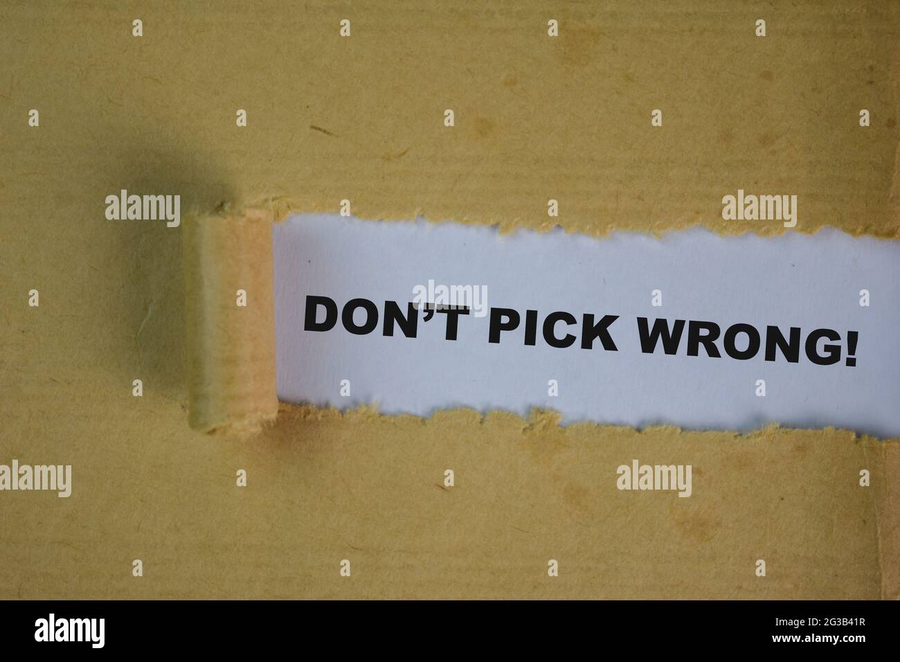 Don't pick wrong Text written in torn paper Stock Photo - Alamy