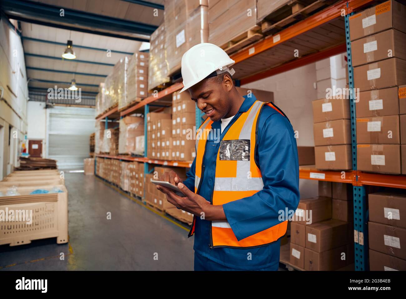 Smiling male supervisor checking stock records in digital tablet ...
