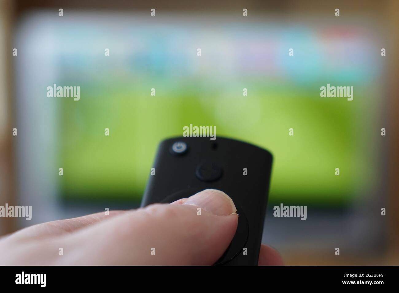hand pointing remote control at tv with soccer or football match Stock ...