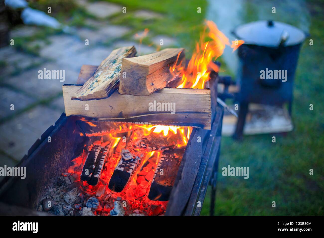 Cooking in a cauldron on the fire. Picnic outdoors in summer. Close-up ...