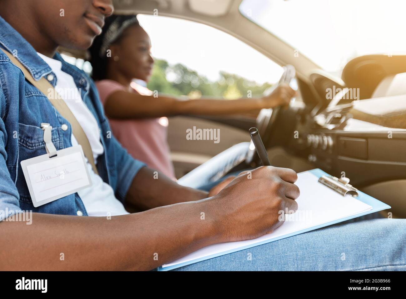 Driving school concept. Cropped of black instructor examinating young ...