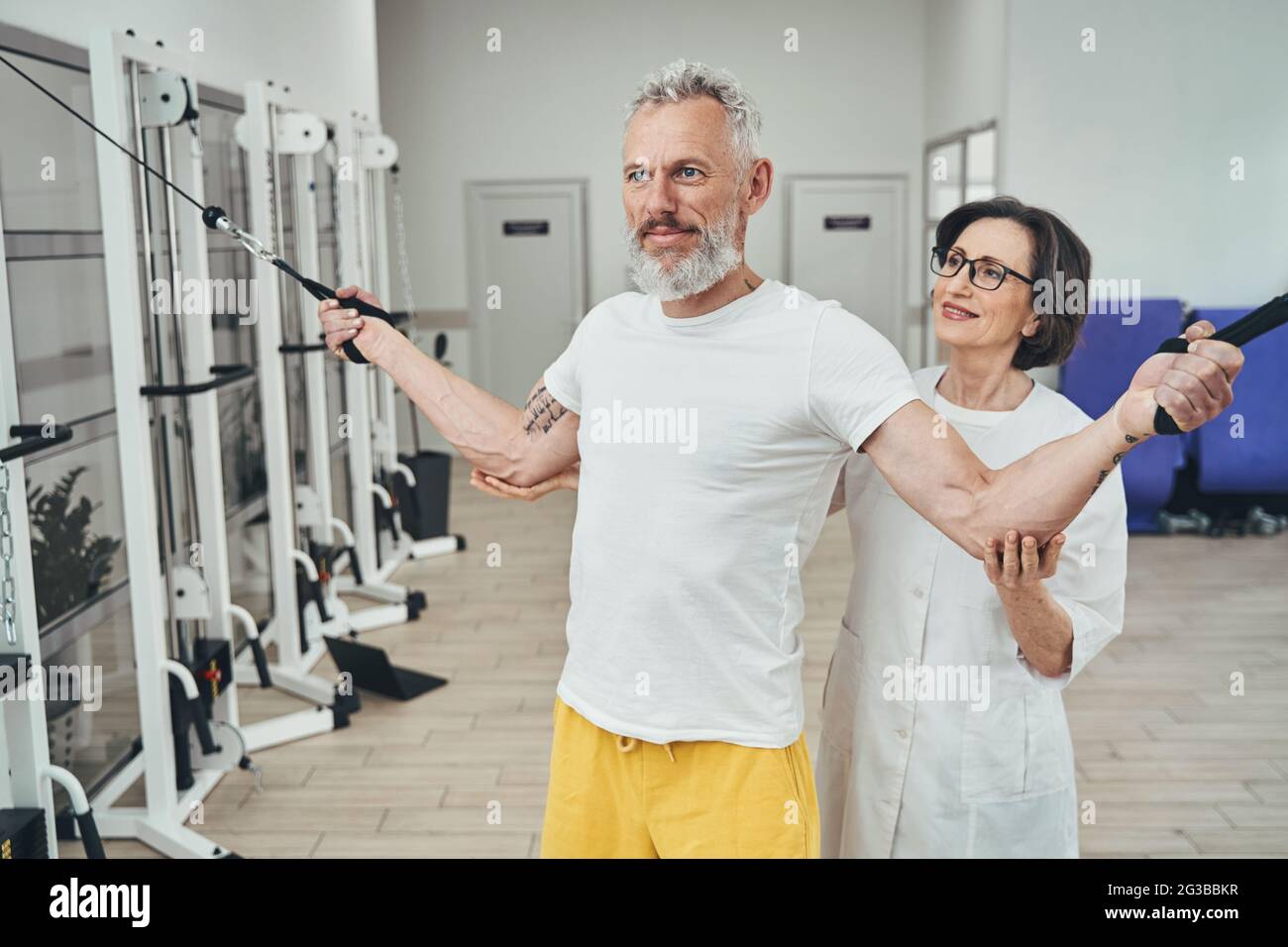 Sportsman performing a standing lateral bicep cable curl Stock Photo ...