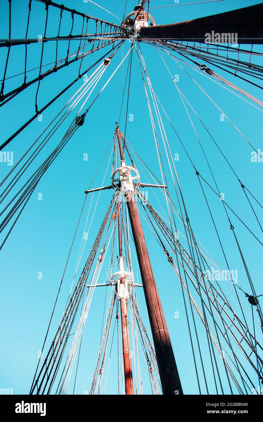 Masts with rigging on a cruise yacht rushing up to the blue sky. Active ...