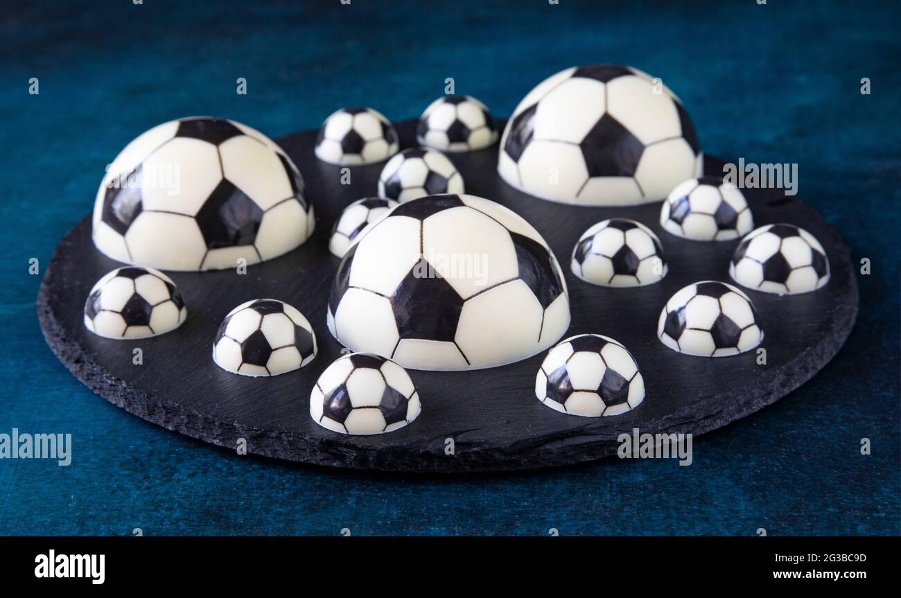 A delicious dessert of chocolate football balls of different shapes on ...