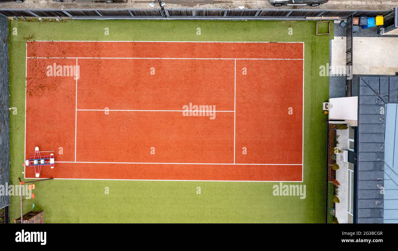 Aerial view of a red-green tennis court with black fences Stock Photo ...
