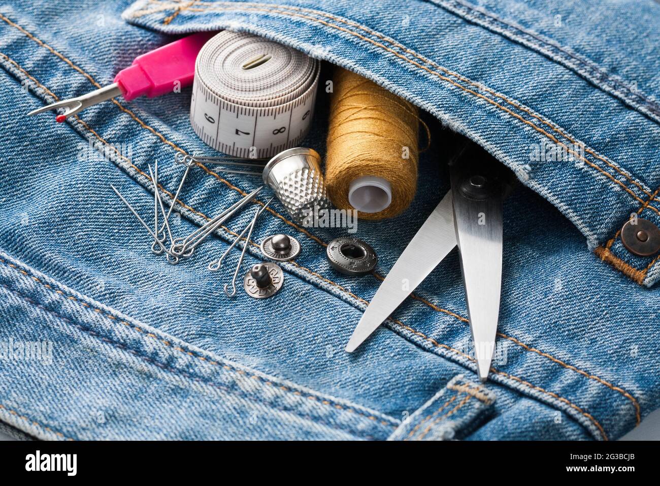 Sewing Tools In Pocket Of Blue Jeans Close Up Stock Photo - Alamy
