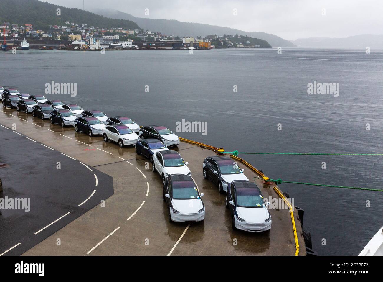 cars line up on harbour dock waiting to be loaded in Bergen Norway ...