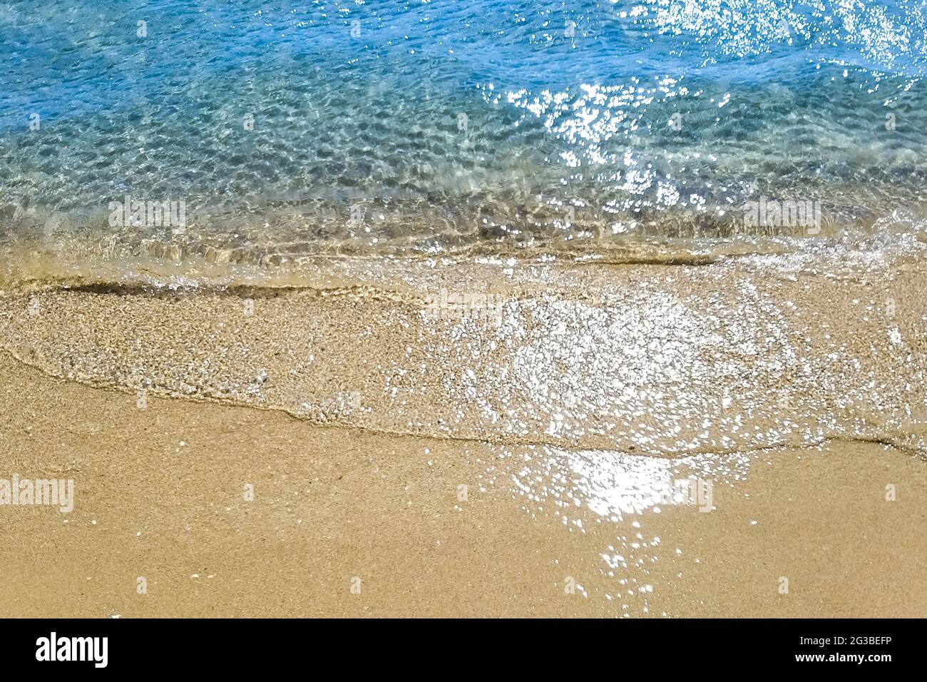 Gentle sea waves on a sandy beach, full frame nature background concept ...
