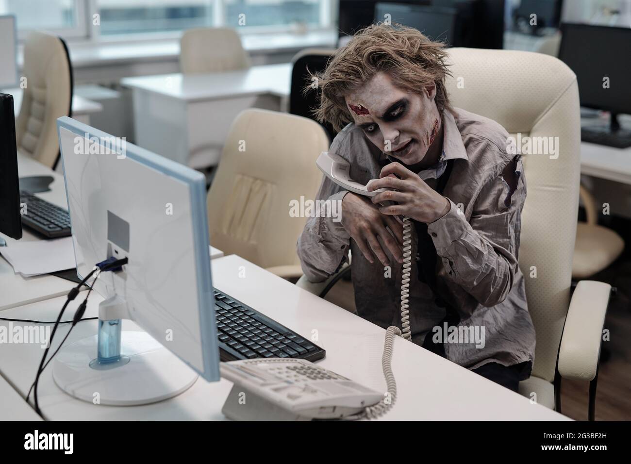 Zombie man with grey greesepaint all over body going to make telephone ...