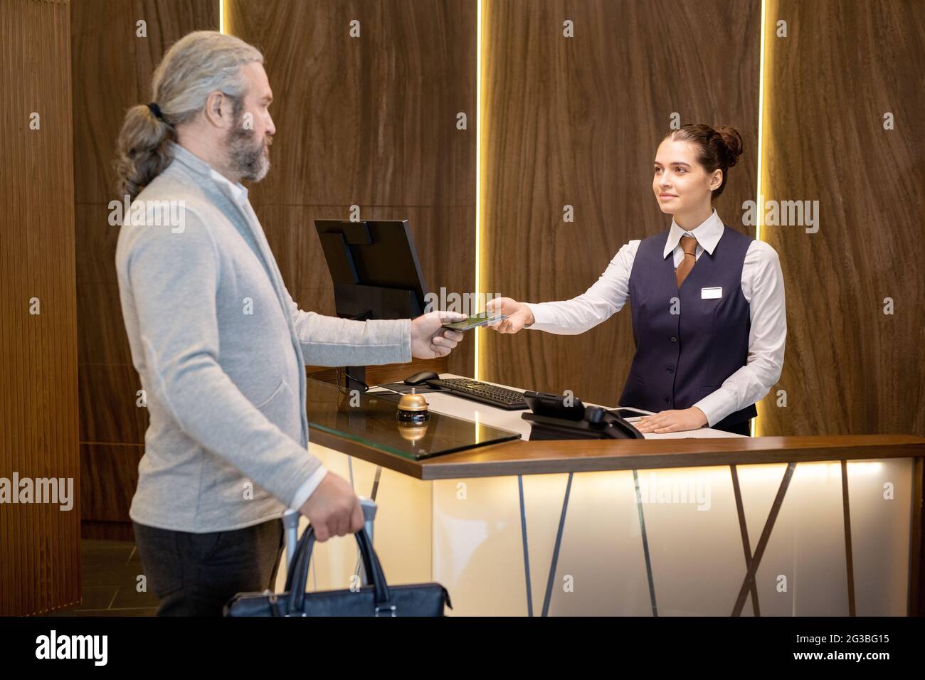 Young receptionist taking documents hi-res stock photography and images ...