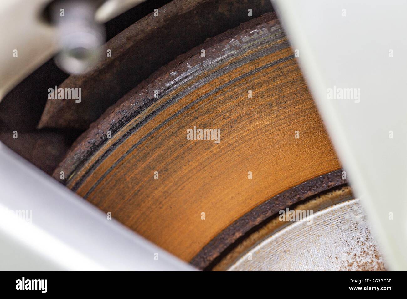 Rusty, defective brake disc with a shoulder on the edge. Worn brake ...