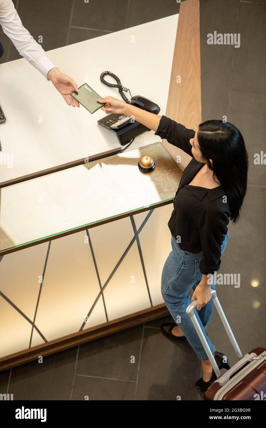 Person taking suitcase hi-res stock photography and images - Alamy